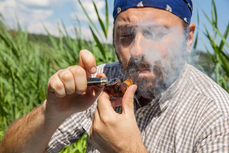 Man smiking pipe stock image. Image of lifestyle, enjoyment - 84283091