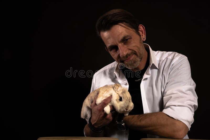 Man holds a dwarf bunny stock photo. Image of business - 115076630