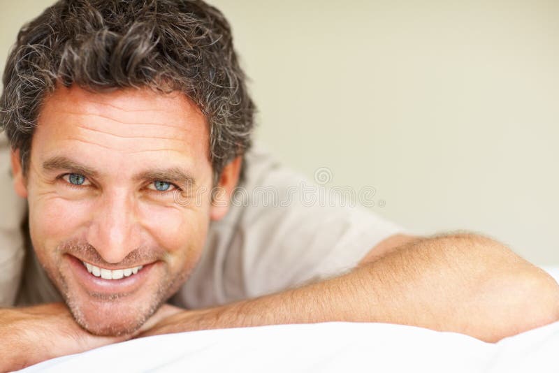 Man Smiling on Bed. Closeup of Mature Man Relaxing on Bed and Smiling ...
