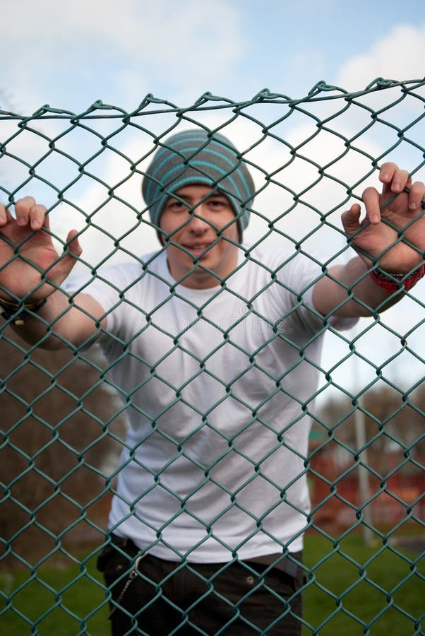 Man smiling behind fence 2 stock photo. Image of tall - 18708678