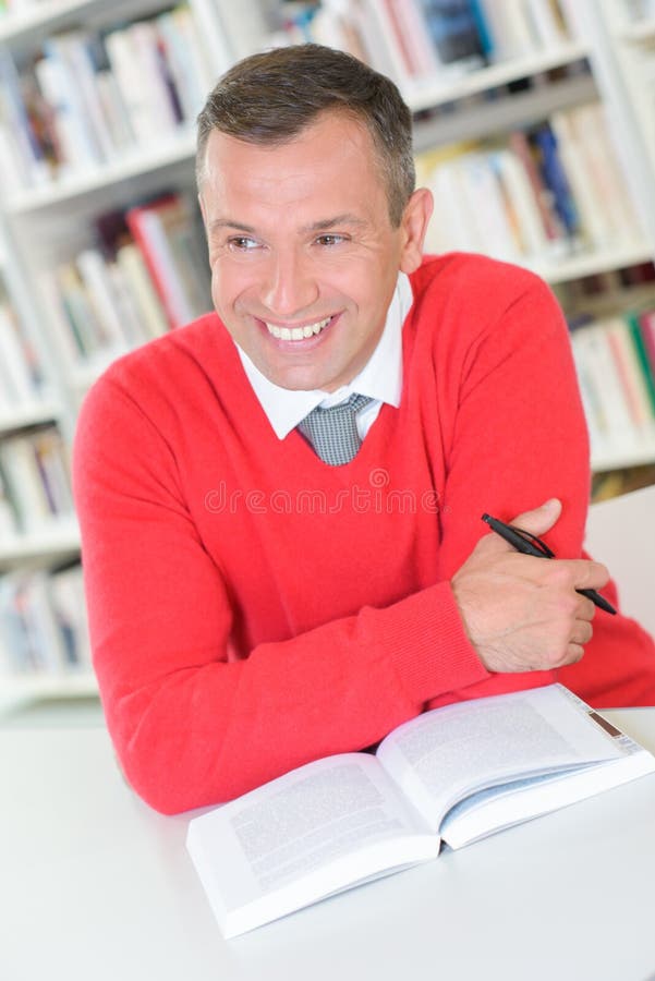 Man smiling with book stock image. Image of library, phrase - 84258233