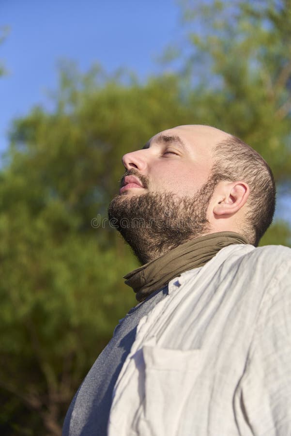 Man Smiling with a Calm and Peaceful Expression Outdoors. Low Angle ...