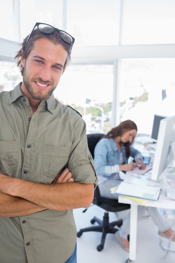 Man Smiling in Creative Office with Arms Folded Stock Image - Image of ...