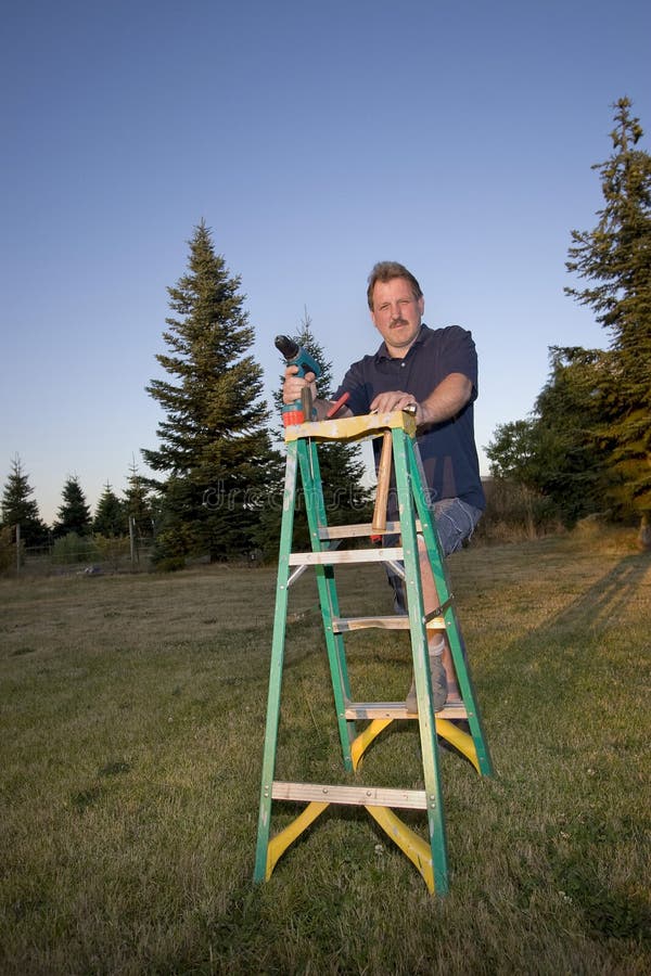Man Smiling with Drill and Ladder Stock Image - Image of drill, ladder ...
