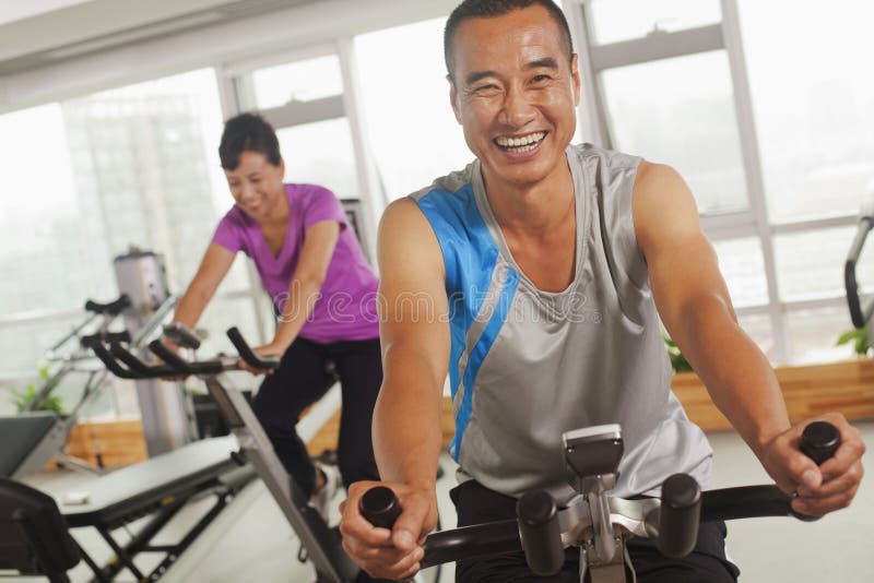 Man Smiling and Exercising on the Exercise Bike Stock Image - Image of ...