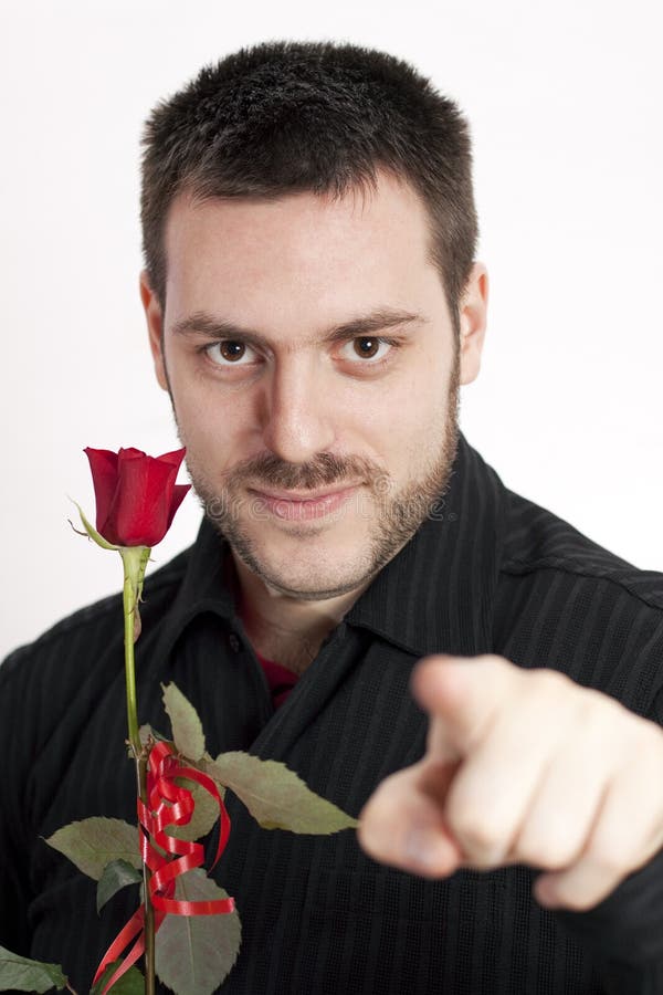 Man Smiling Hodling Red Rose Pointing His Finger Picture. Image: 8148976