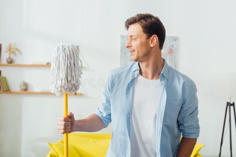 Man Smiling while Holding Mop in Stock Image - Image of equipment ...