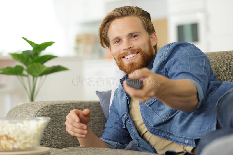 Man Smiling Holding Remote Control Stock Image - Image of film, plasma ...