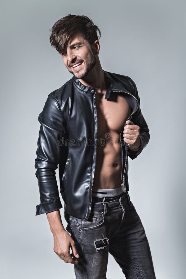 Man Smiling and Posing in Leather Jacket and Jeans Stock Image - Image ...