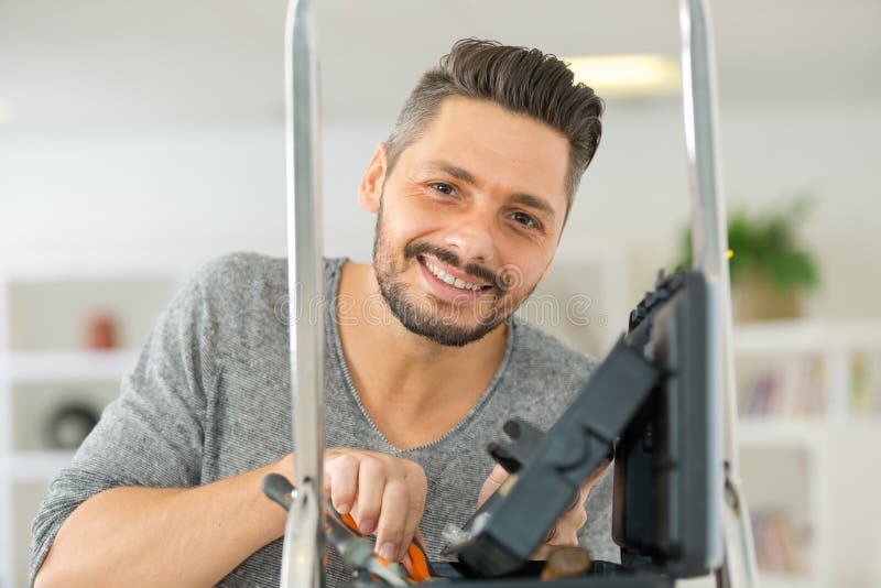 Man Smiling while Taking Out Tool from Toolbox Stock Photo - Image of ...