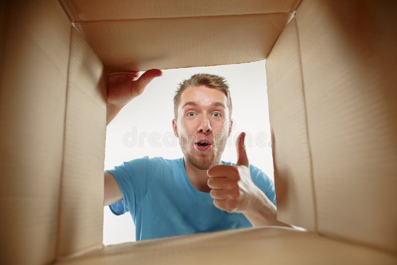 Man Smiling, Unpacking and Opening Carton Box and Looking Inside Stock ...