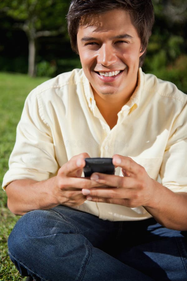 Man Smiling while Writing a Text Message Stock Photo - Image of ...
