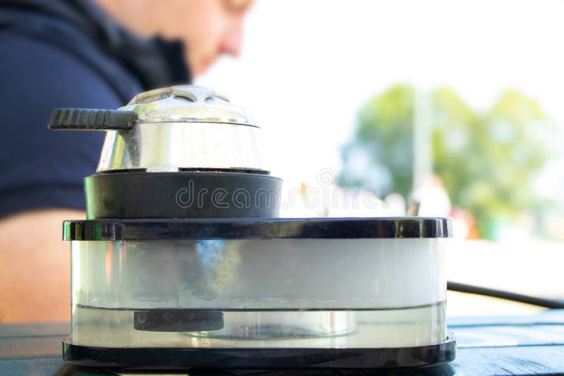A Man Smokes a Hookah on a Mountain in Bukovel in the Summer in the Sun ...