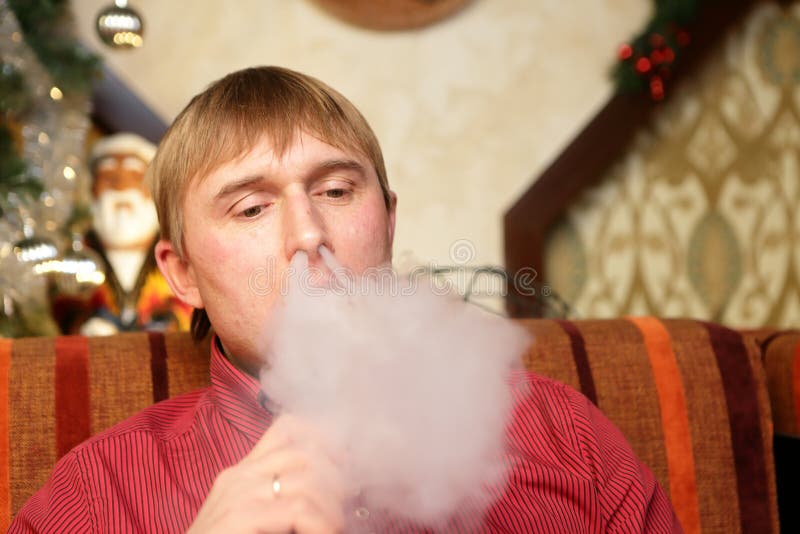 Man smoking shisha stock photo. Image of indoor, person - 64483084