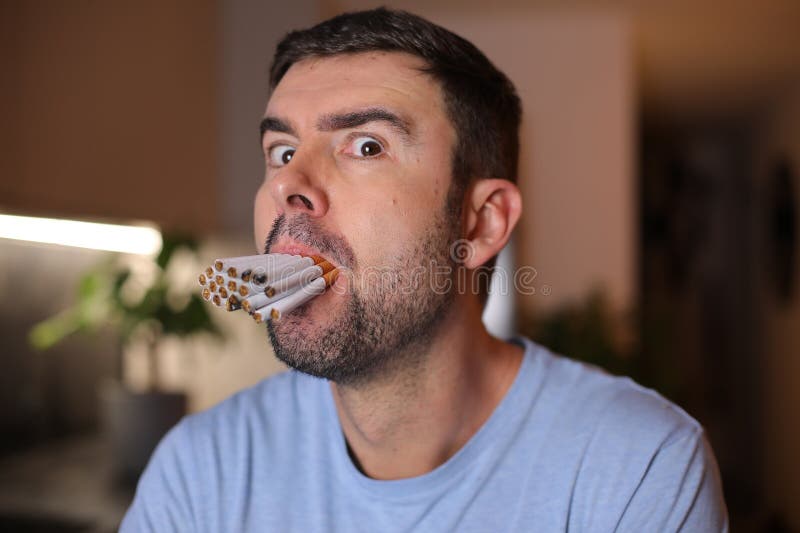 Man Smoking Too Many Cigarettes at the Same Time Stock Image - Image of ...