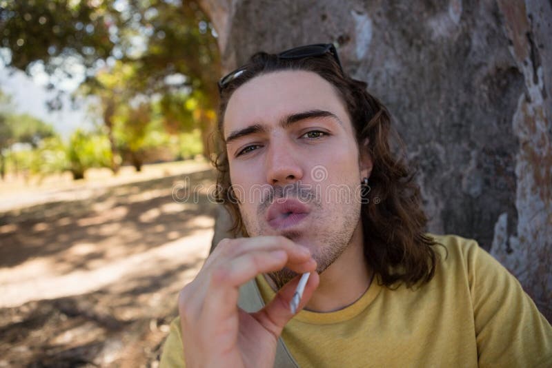 Man Smoking Weed in the Park Stock Photo - Image of summertime, people ...