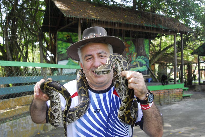 Man with Snake Around His Neck Stock Photo - Image of outdoors, reptile ...