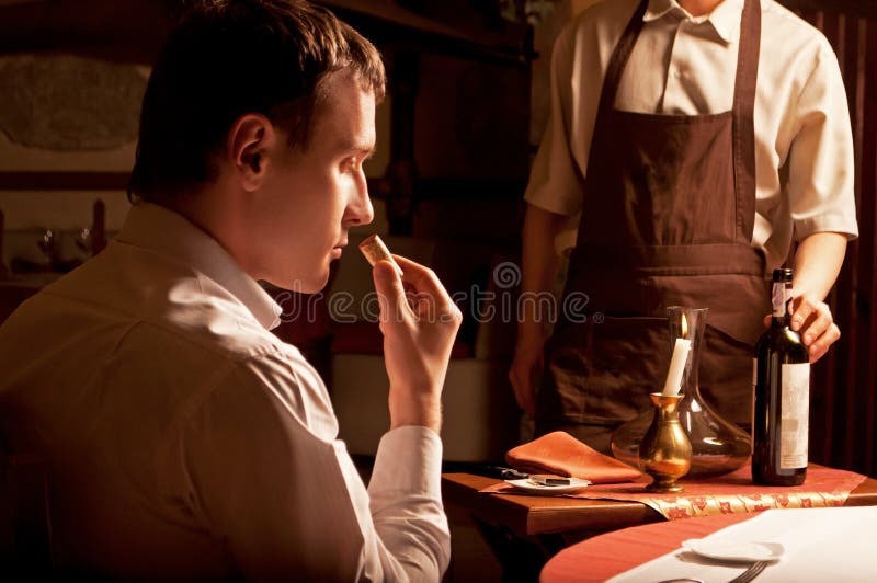 Man Sniffing the Cork of a Wine Stock Image - Image of drink, candle ...