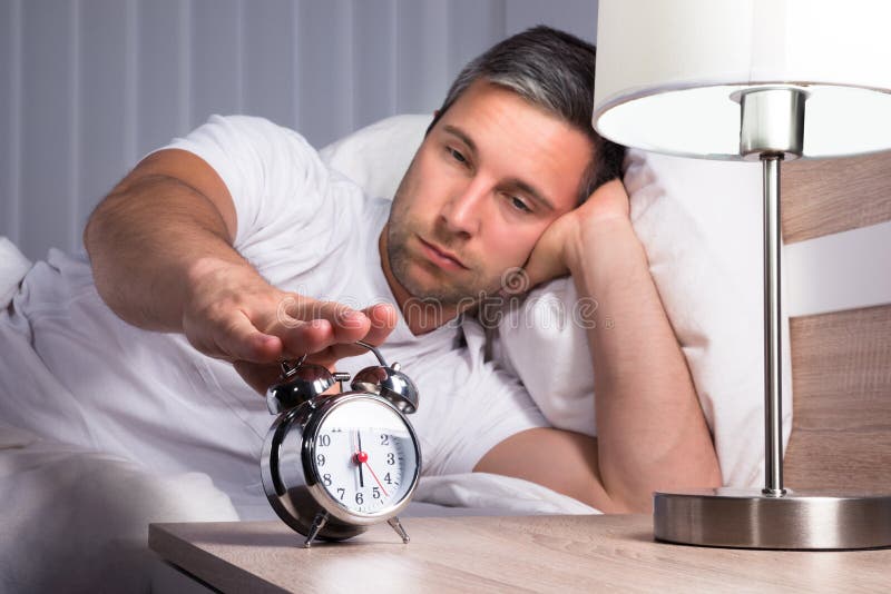 Man Snoozing Alarm Clock on Cell Phone Stock Image - Image of house ...