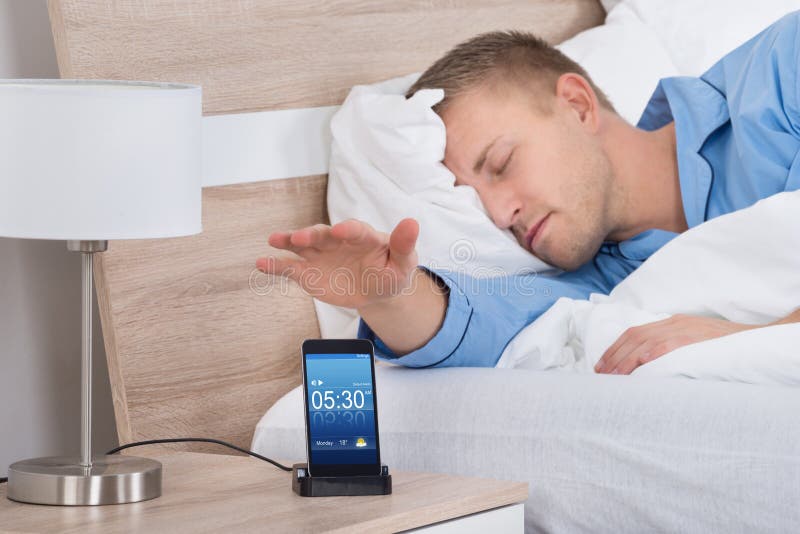 Man Snoozing Alarm Clock On Cell Phone Stock Image - Image of house ...