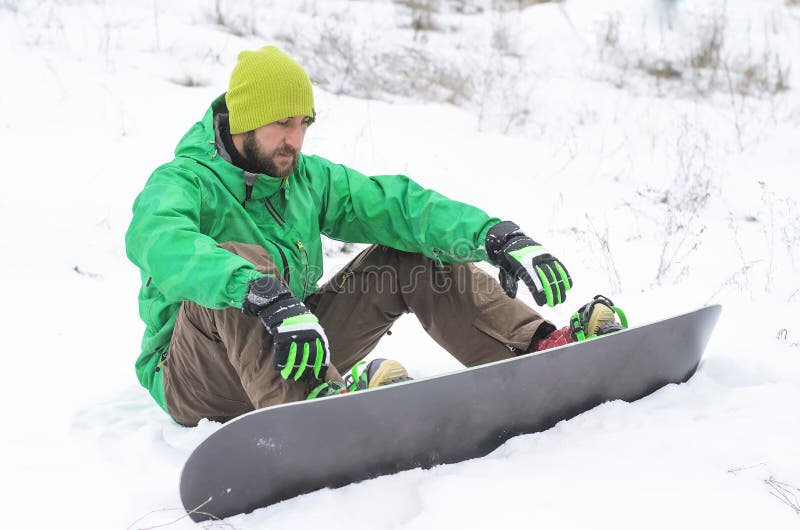 Man Snowboarder Sitting in the Snow. Stock Photo - Image of cold ...