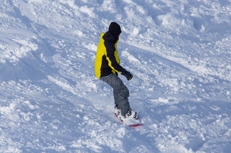 A Man Snowboarding a Mountain in the Snow in Winter Stock Image - Image ...
