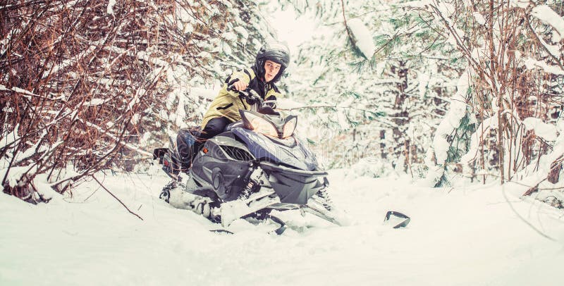 Man on Snowmobile in Winter Mountain. Snowmobile Driving. Man Driving ...