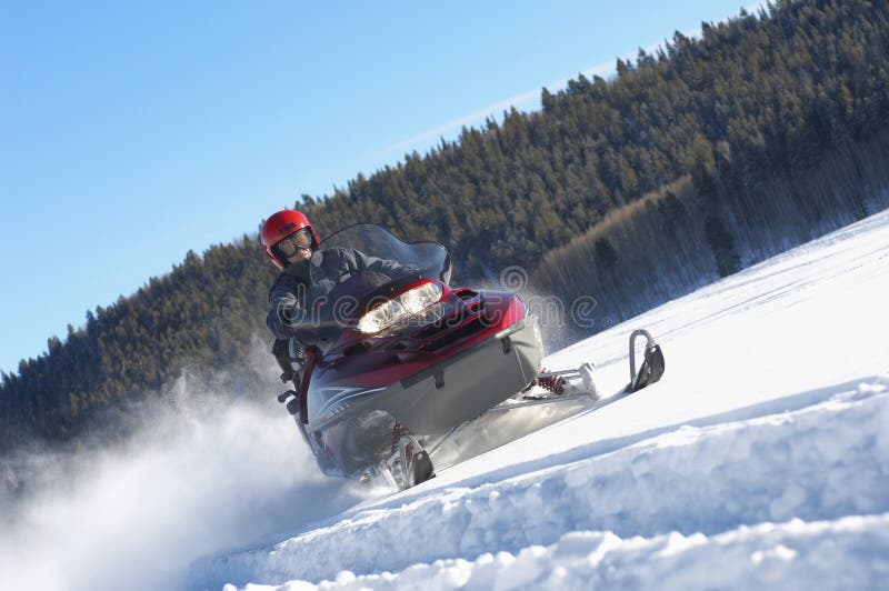 Man Snowmobiling through Snow Stock Image - Image of snowmobile ...