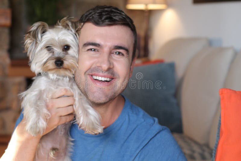 Man in sofa with small dog stock image. Image of animal - 197455095