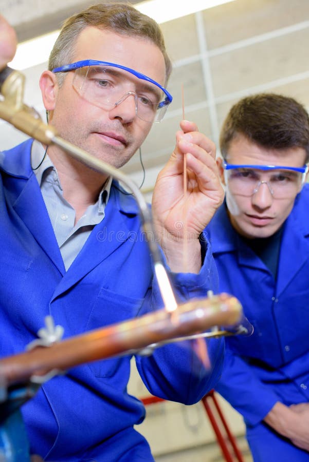 Man Soldering Apprentice Observing Stock Image - Image of safety ...