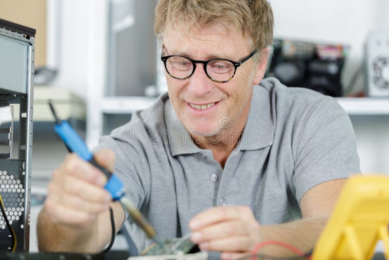 Man with Soldering Iron Repairs Computer Equipment Stock Photo - Image ...
