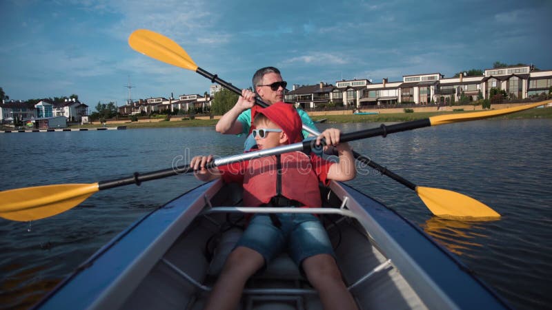 Man and son kayaking stock video. Video of leisure, boat - 94589665