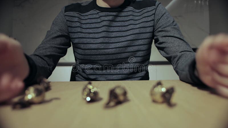 A Man is Sorting through Chocolates in His Hands and Throws Them on the ...