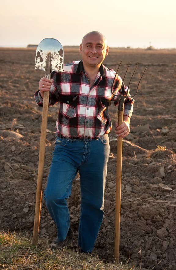 Man with Spade and Pitchfork Stock Image - Image of adult, land: 19921555