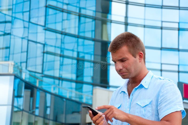 Man Speaking on Phone in Front of Modern Business Building Stock Image ...