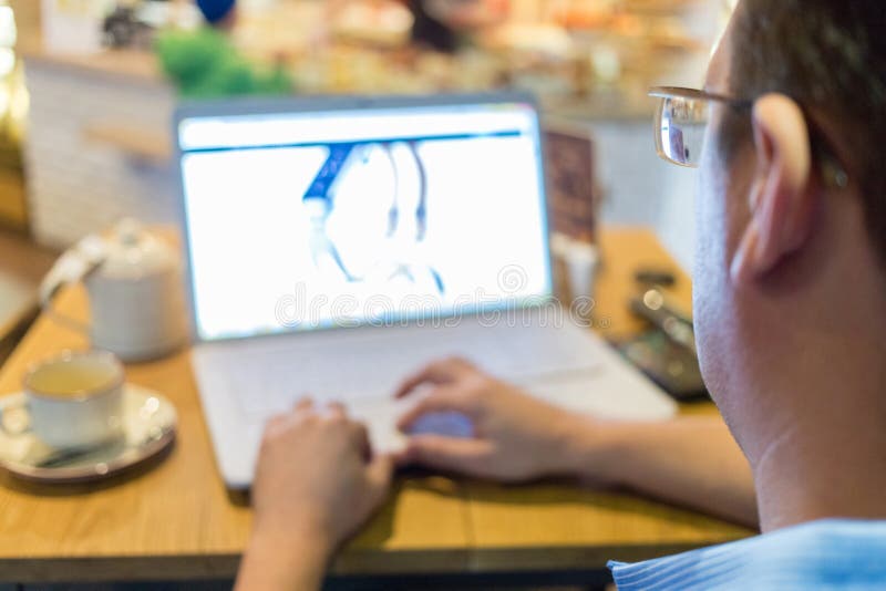 Man Spectacled Looking at His Computer at Cafe, Stock Image - Image of ...