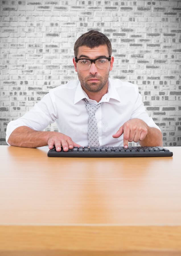 Man in Spectacles Typing on Keyboard Against Brick Wall Background ...