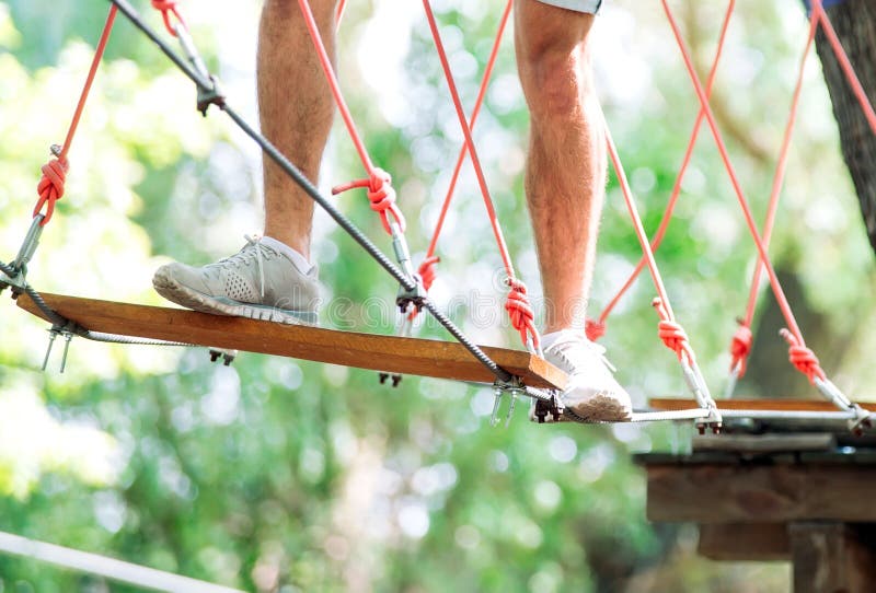 Man Spend Their Leisure Time in a Ropes Course. Man Engaged in Rope ...
