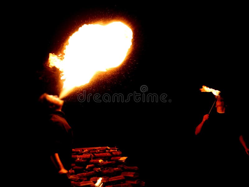 Fire Show.the Man is Spitting Fire and Ignites the Bonfire. Stock Image ...