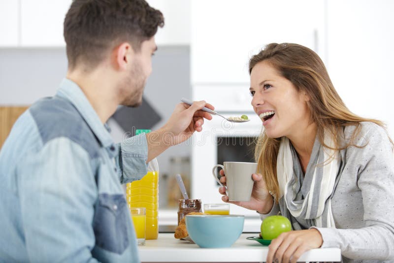 Man Spooning Cereal into Girlfriends Mouth Stock Image - Image of smile ...