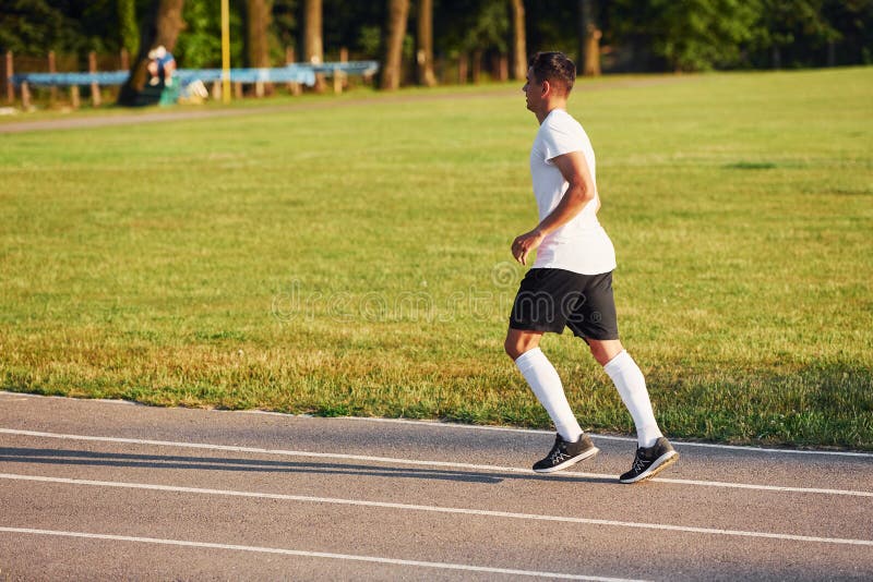 Man in Sportive Unifrom Running on the Track at Daytime Stock Image ...