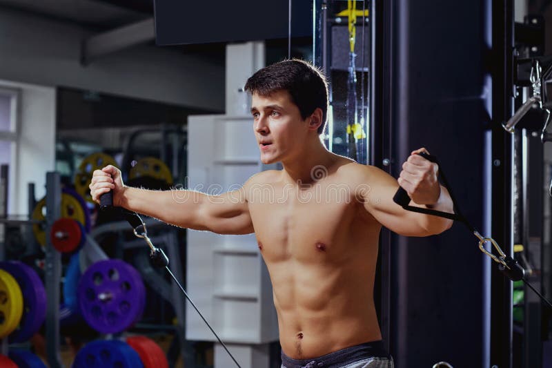 Man with a Sports Figure Doing Exercise on Simulator in the Gym Stock ...