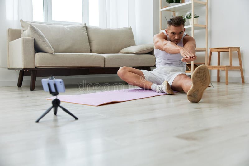 Man Sports Watching A Workout Tape On His Phone And Repeating