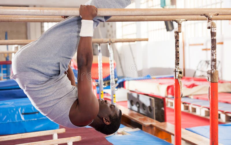 Man in Sportswear Doing Exercises on Parallel Bars Stock Photo - Image ...