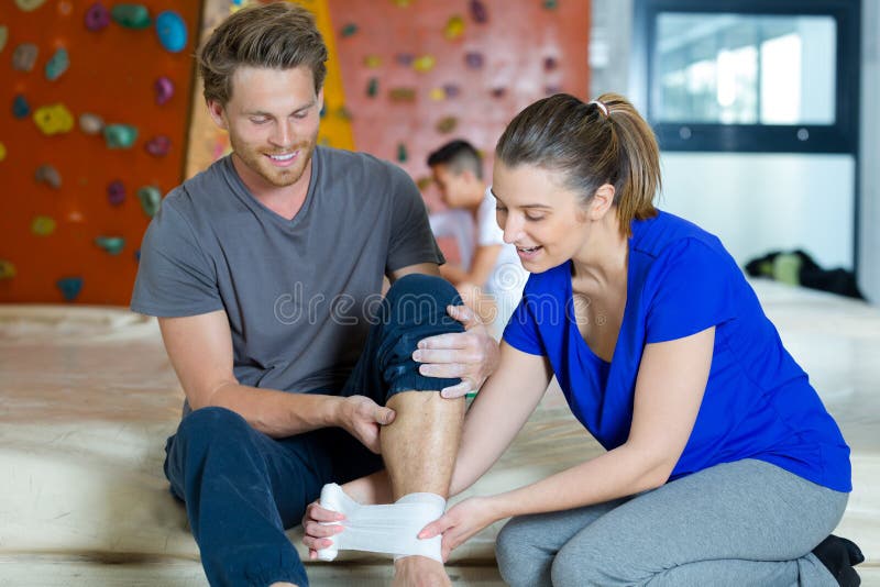 Man with Sprained Ankle and Getting Help from Woman Stock Image - Image ...