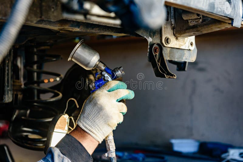 Man Spraying an Anti-corrosion Compound on Bottom of Car. Stock Image ...