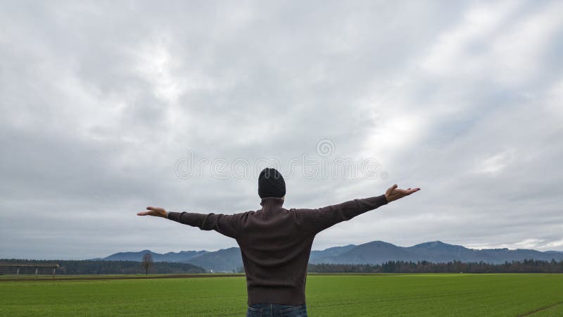 Man with Spread Arms Standing Under Dramatic Sky Stock Photo - Image of ...