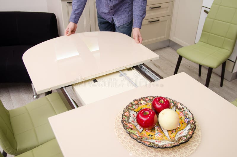 Man Spreads a Sliding Glossy Dining Table on Which Stands a Plate with ...
