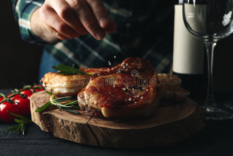 Man Sprinkles Salt on Steaks Composition with Grilled Food Stock Photo ...