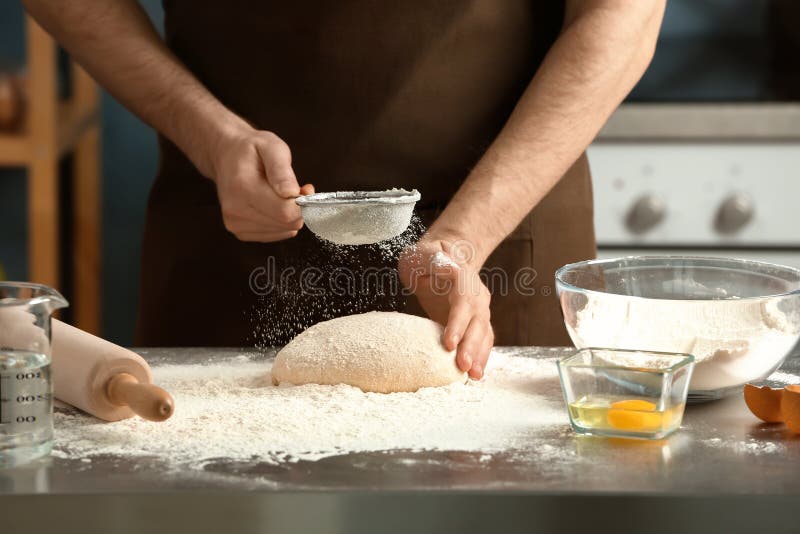 Man Sprinkling Flour Over Dough on Table Stock Image - Image of adult ...